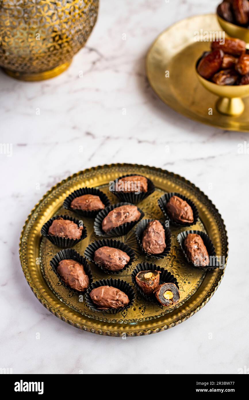 Almond stuffed dates coated with dark chocolate Stock Photo - Alamy