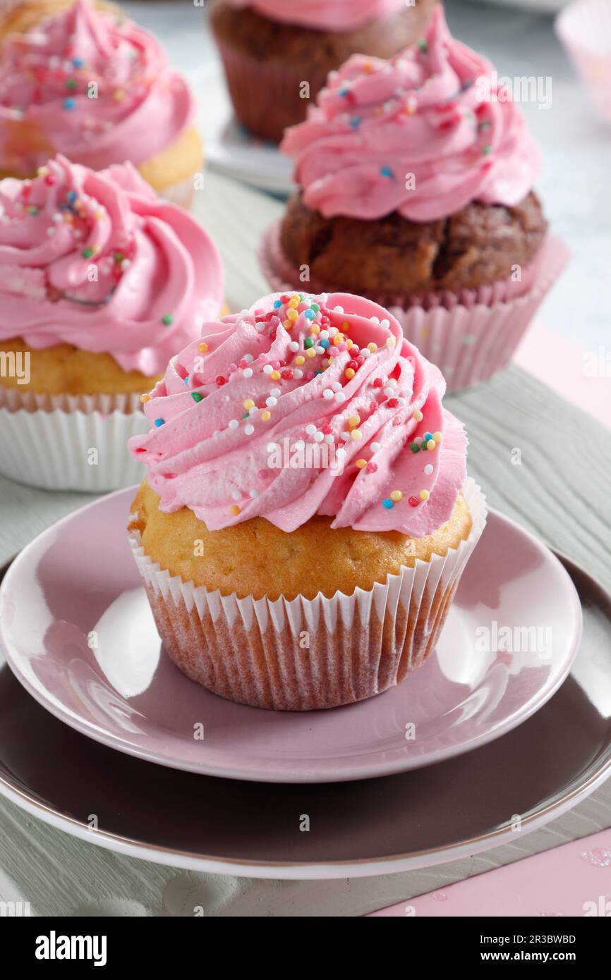 Muffins with rose cream decorated with sprinkles Stock Photo - Alamy