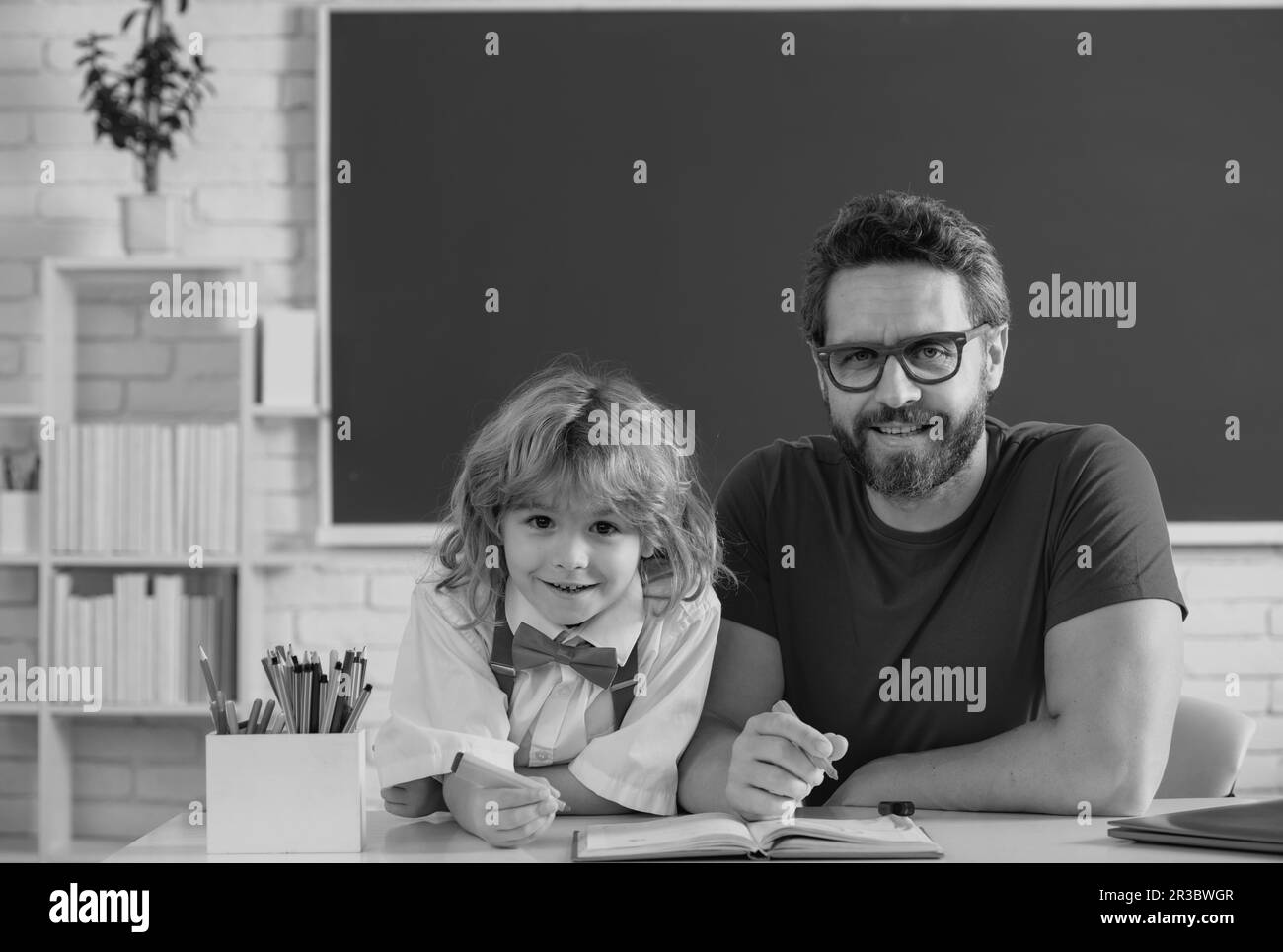 Pupil kid student and teacher tutor in classroom at school lesson ...