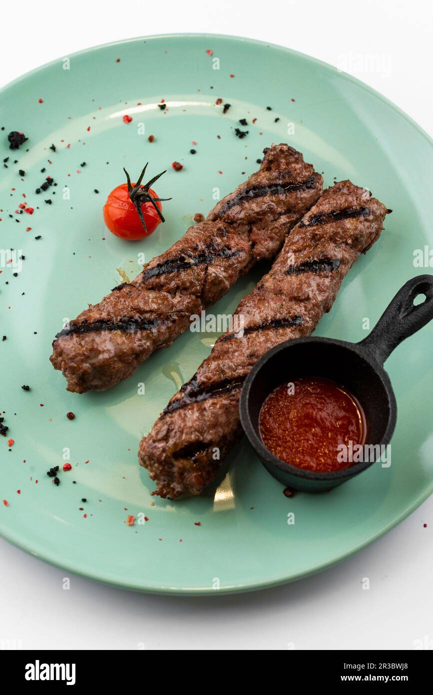 Turkish kebab with tomato sauce Stock Photo - Alamy