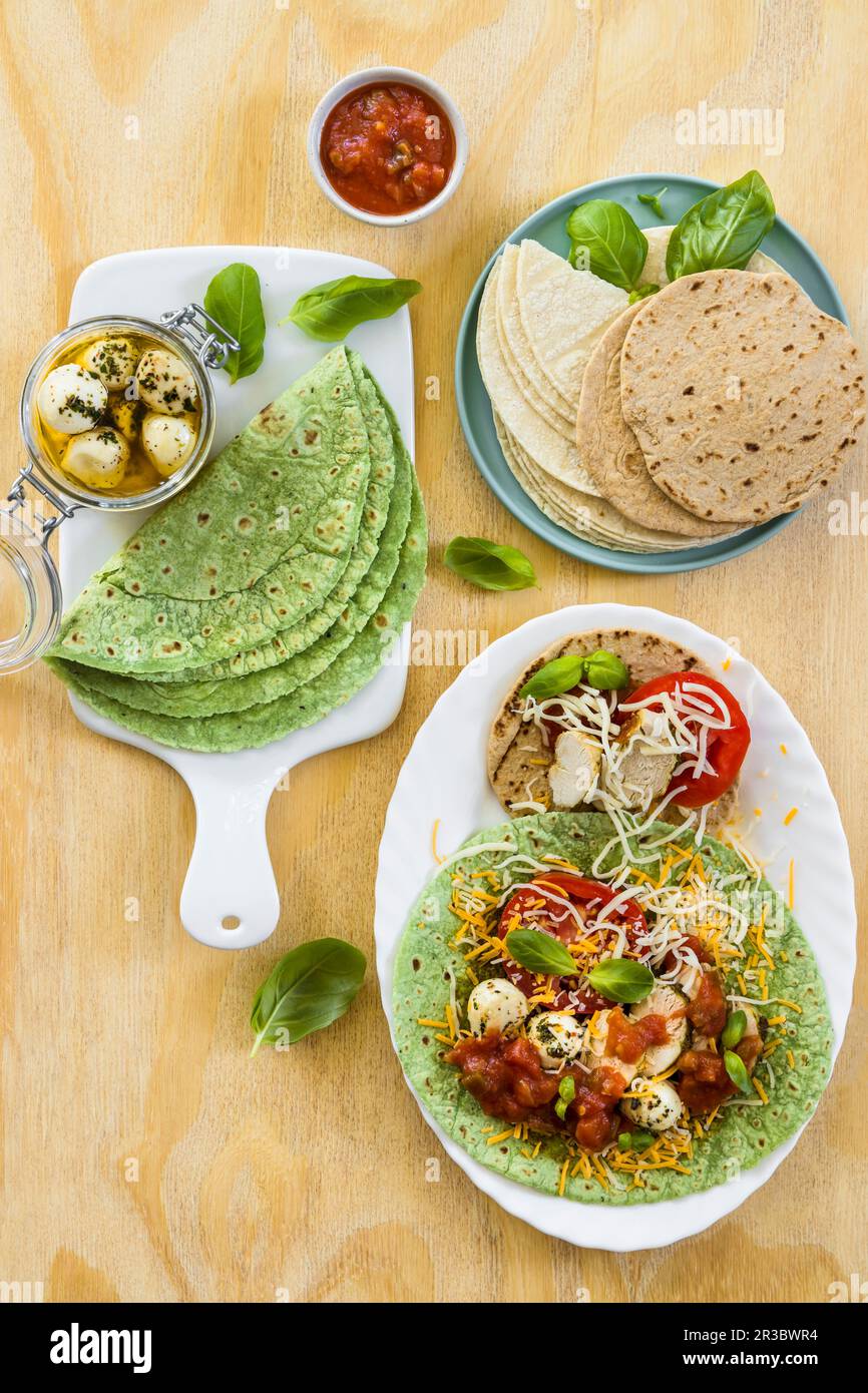 Taco party, spinach and wholegrain tacos with chicken, cheeses and ...