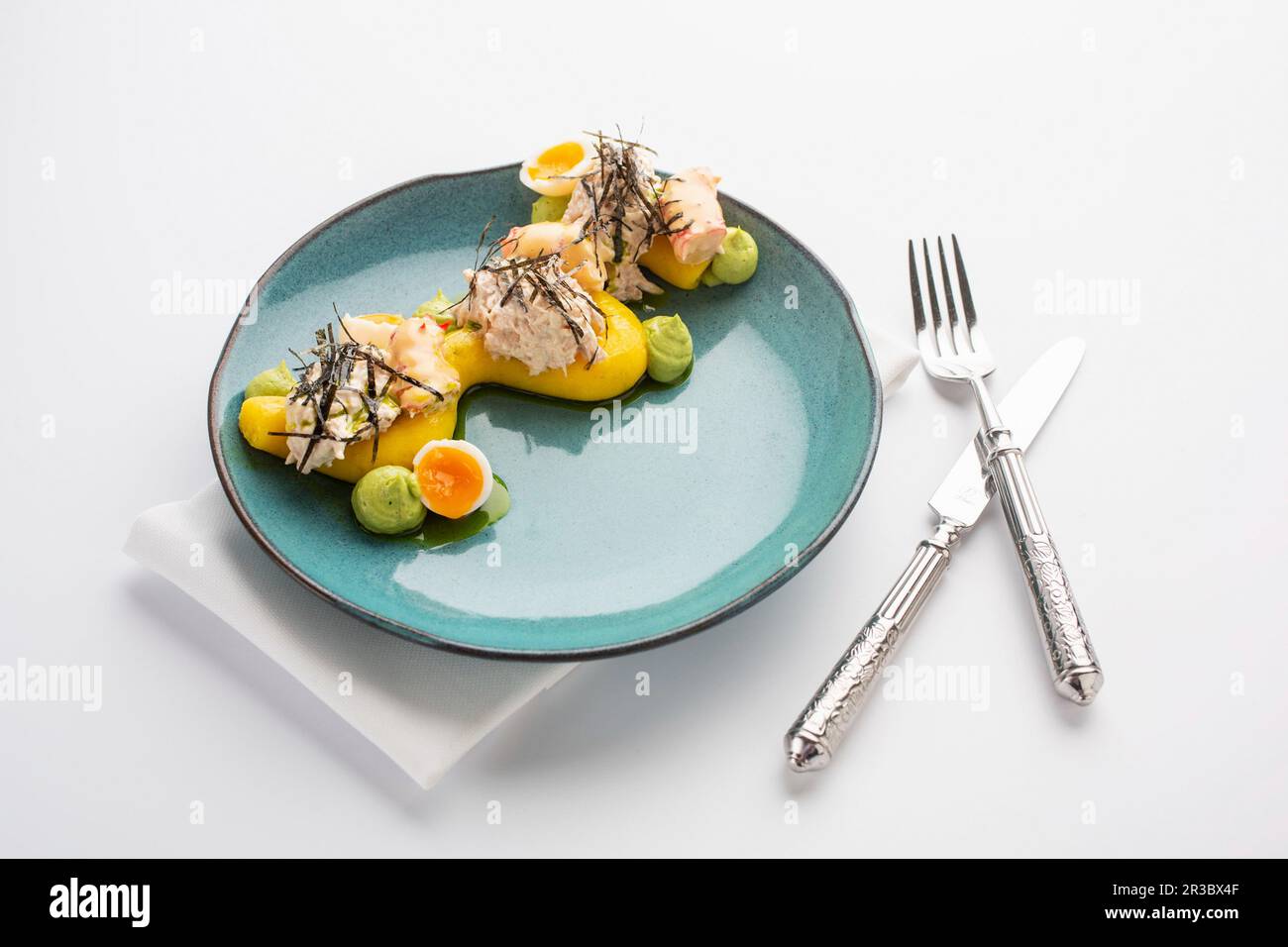 King crab, confit chicken and quail eggs Stock Photo - Alamy