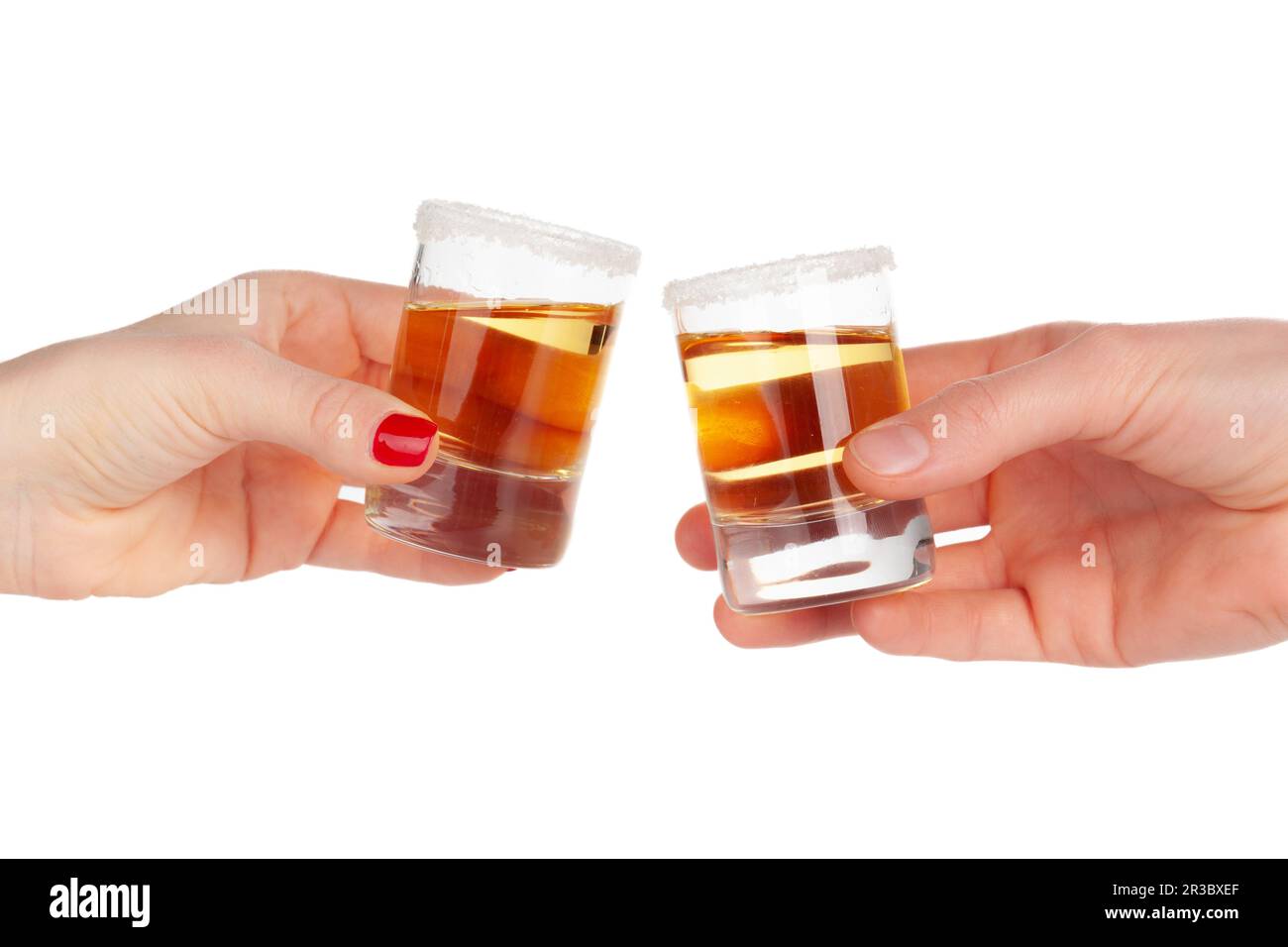 Two hands clinking shots of alcoholic beverage together Stock Photo - Alamy