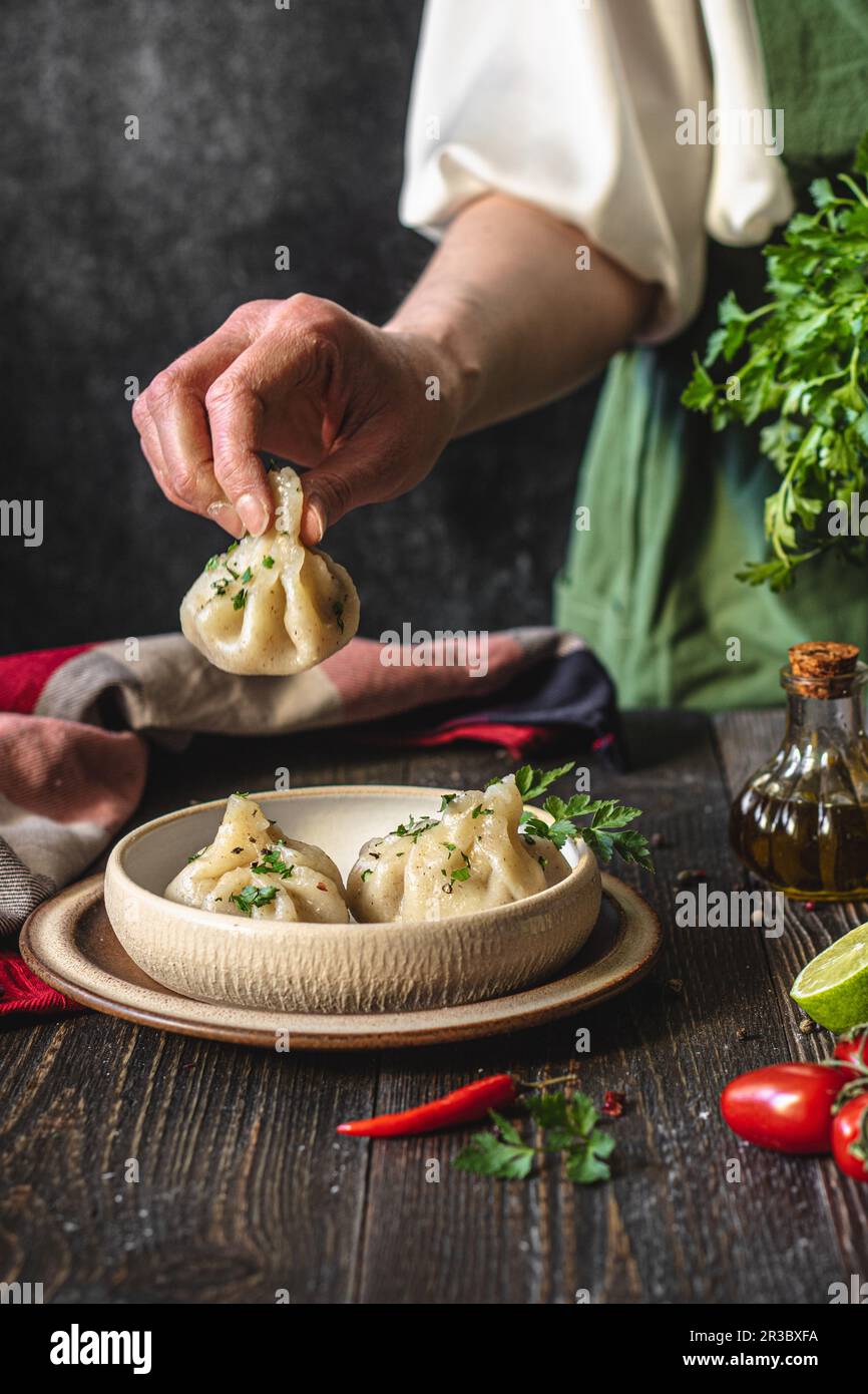 Woman holding a chinkali Stock Photo - Alamy