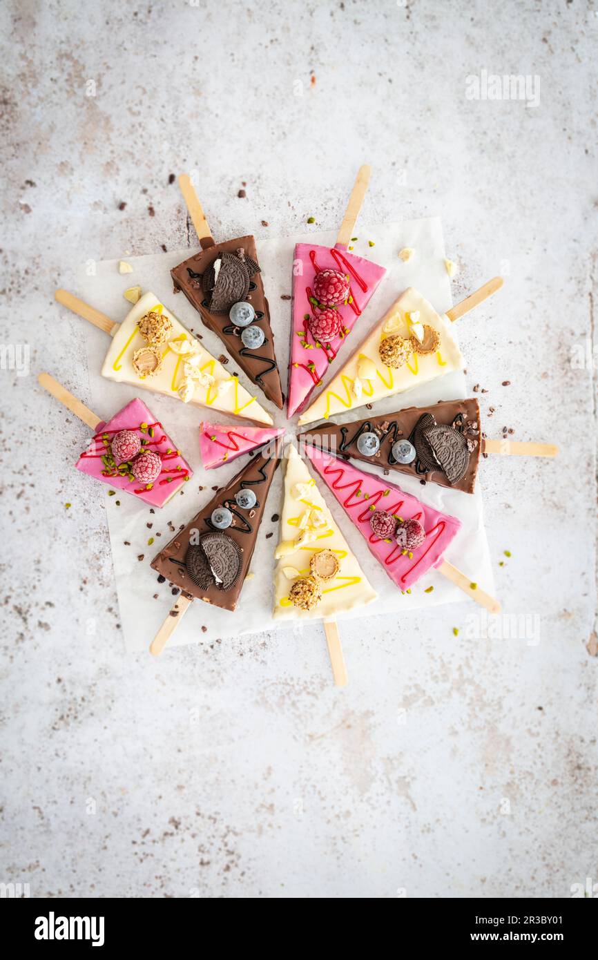 Three different types of cheesecake slices on sticks Stock Photo - Alamy