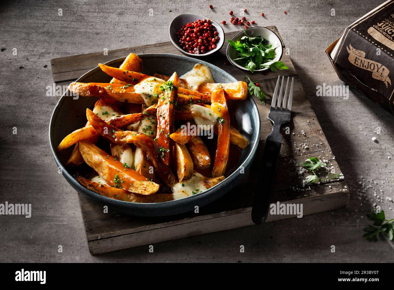 Canadian poutine (fast food specialty made from french fries, cheese ...