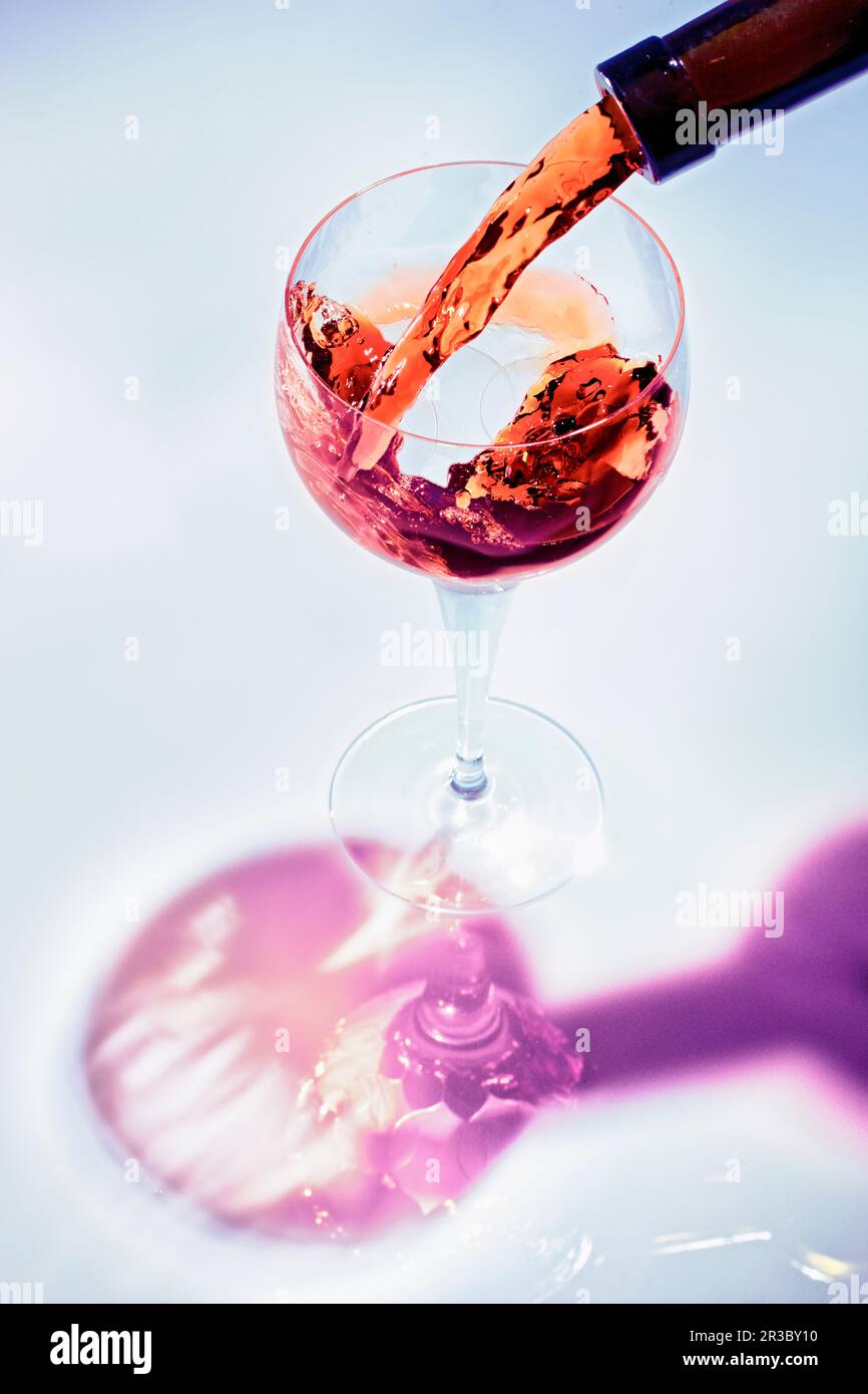 Red wine being poured Stock Photo - Alamy