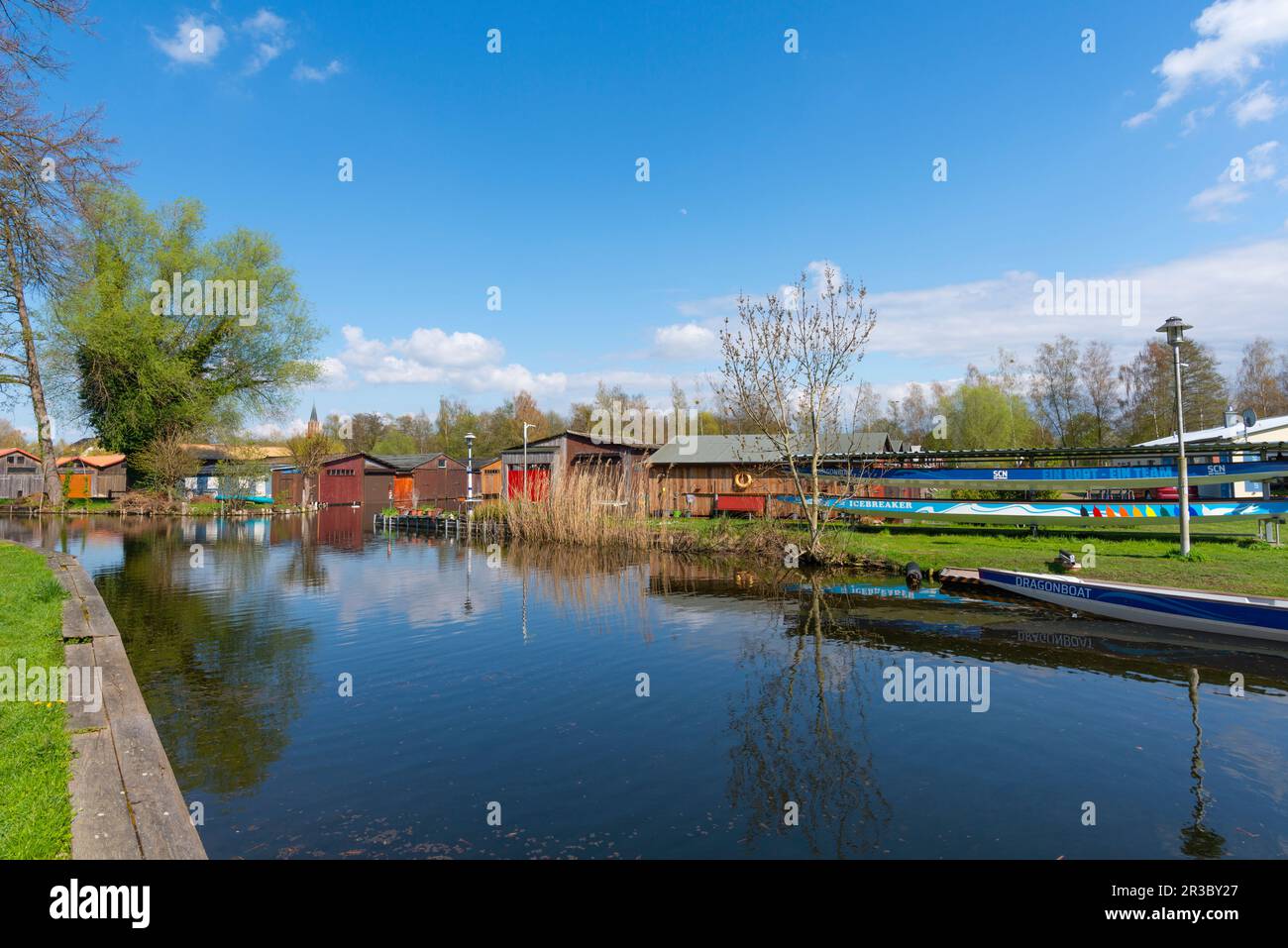 Traditional boat houses along the river Oberbach, town Neubrandenbrug ...