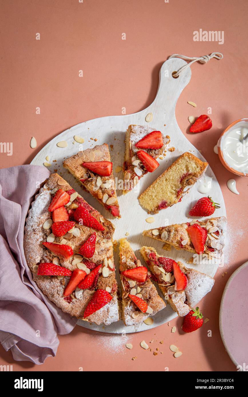 Almond sponge with strawberries and crumble topping Stock Photo - Alamy