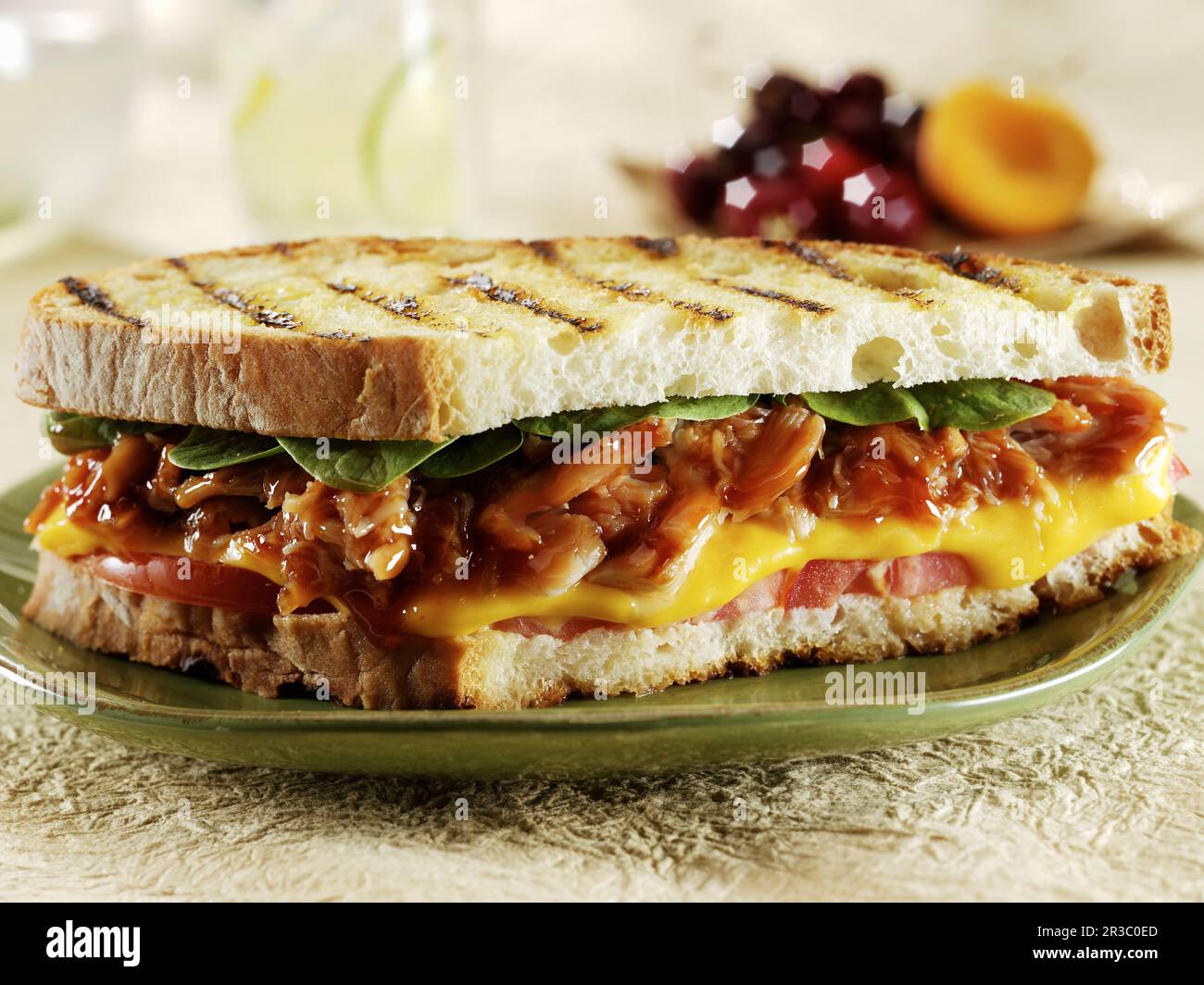 BBQ chicken and cheese pannini with tomato and spinach Stock Photo - Alamy