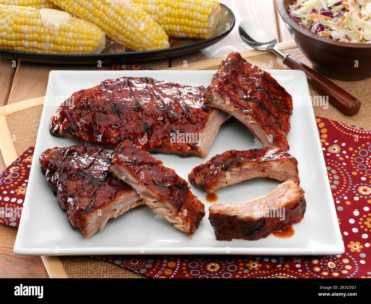 BBQ baby back pork ribs with corn on the cob and cole slaw Stock Photo ...