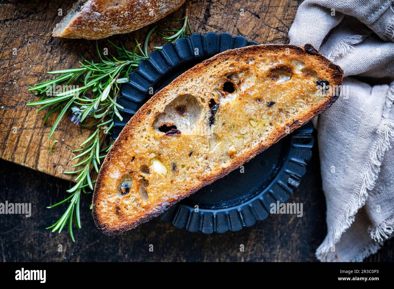 A toasted slice of sourdough olive bread Stock Photo - Alamy