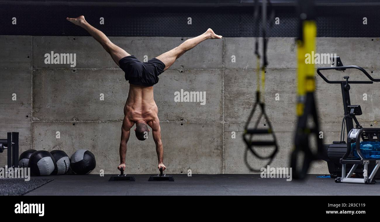 A muscular man in a handstand position, showcasing his exceptional ...