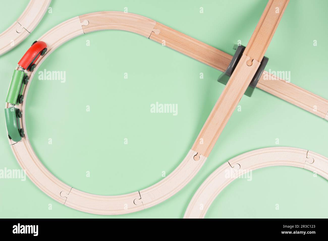 Baby kid toys background. Toy train and wooden rails on light green ...