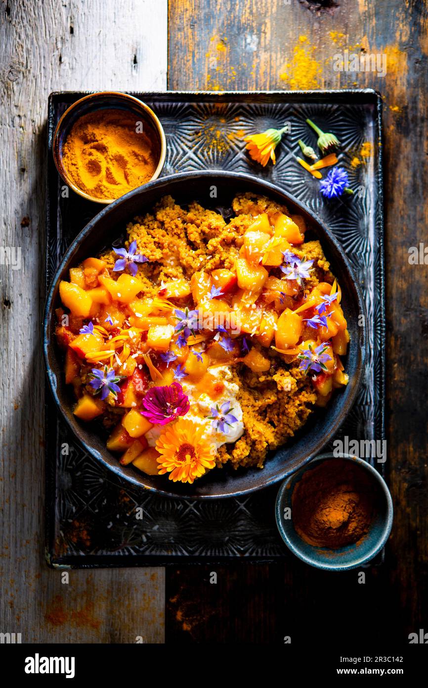 Coconut-turmeric couscous with carmelized cinnamon peaches Stock Photo ...