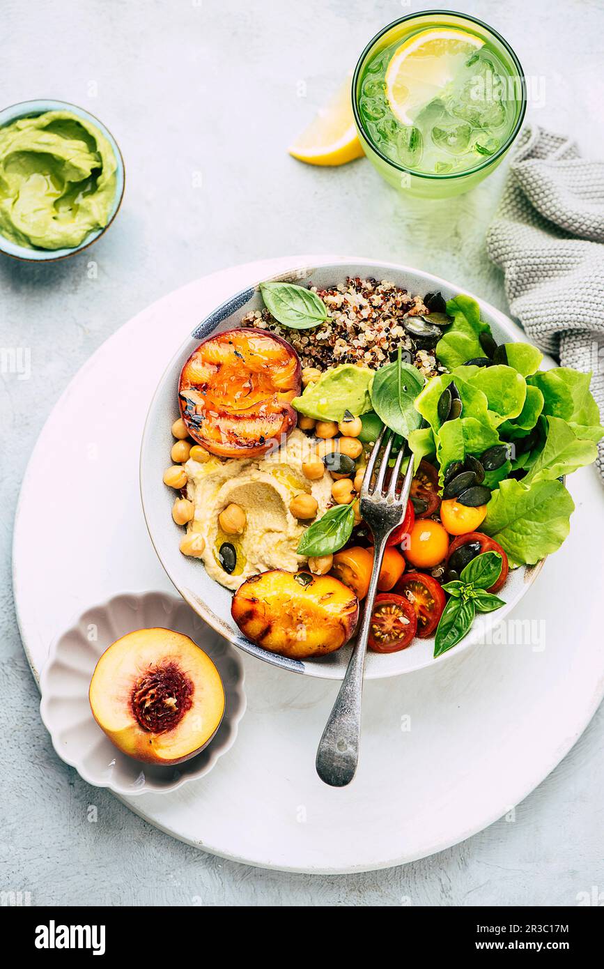 Summer bowl with grilled peach and hummus Stock Photo - Alamy