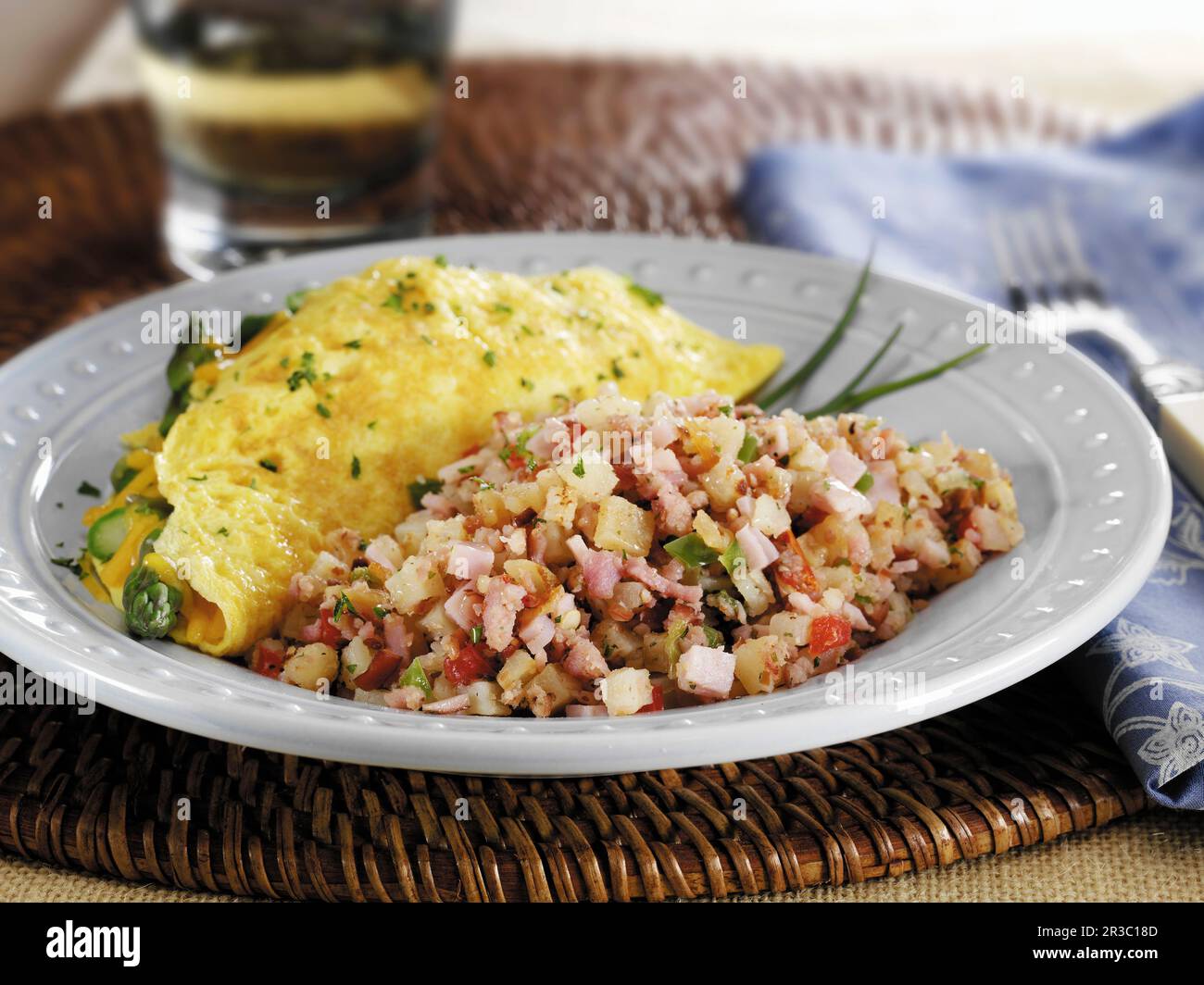 Canadian Bacon hash and an omelette breakfast with chives Stock Photo ...