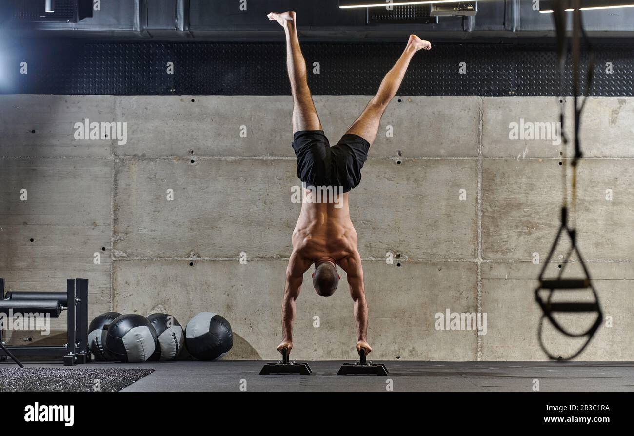 A muscular man in a handstand position, showcasing his exceptional ...
