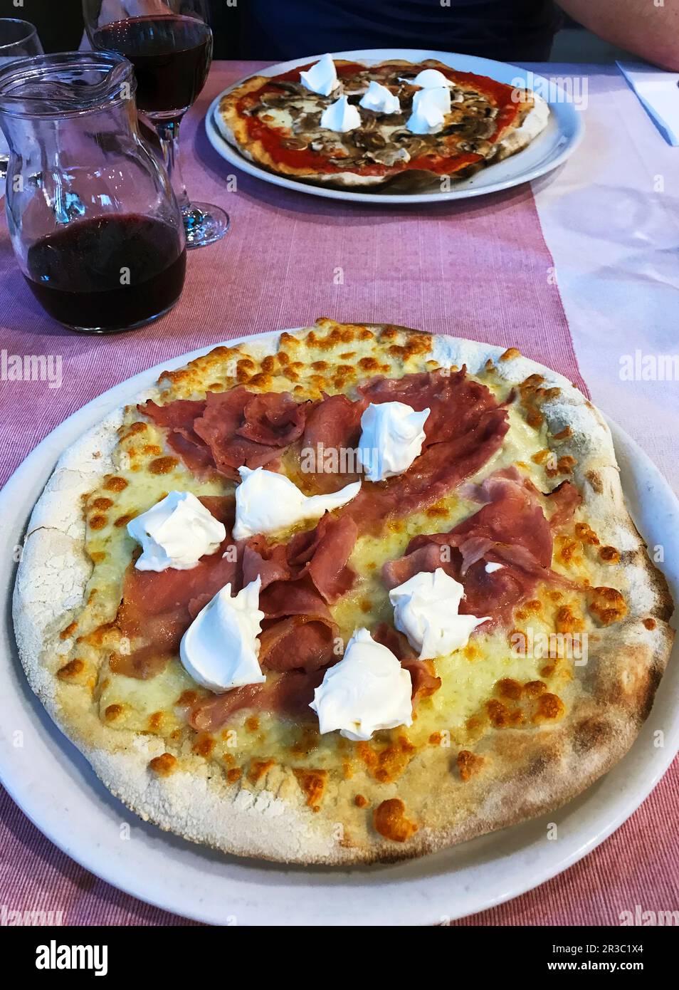 Two different pizzas on a restaurant table Stock Photo - Alamy
