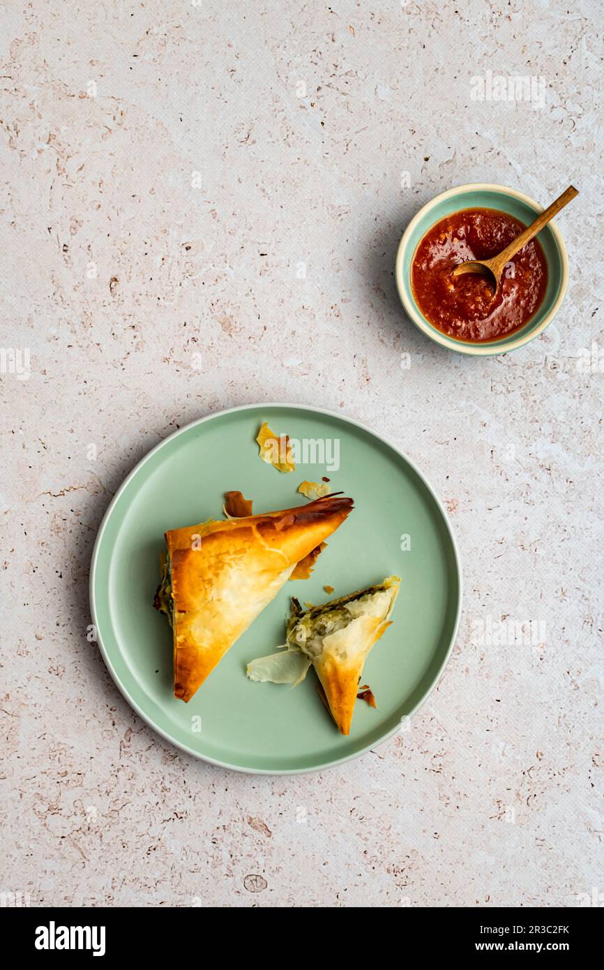 Filo pastry with cheese and spinach filling and sweet chilli sauce ...