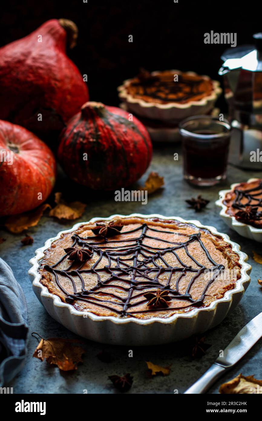 Pumpkin pie with spider web decorations Stock Photo - Alamy