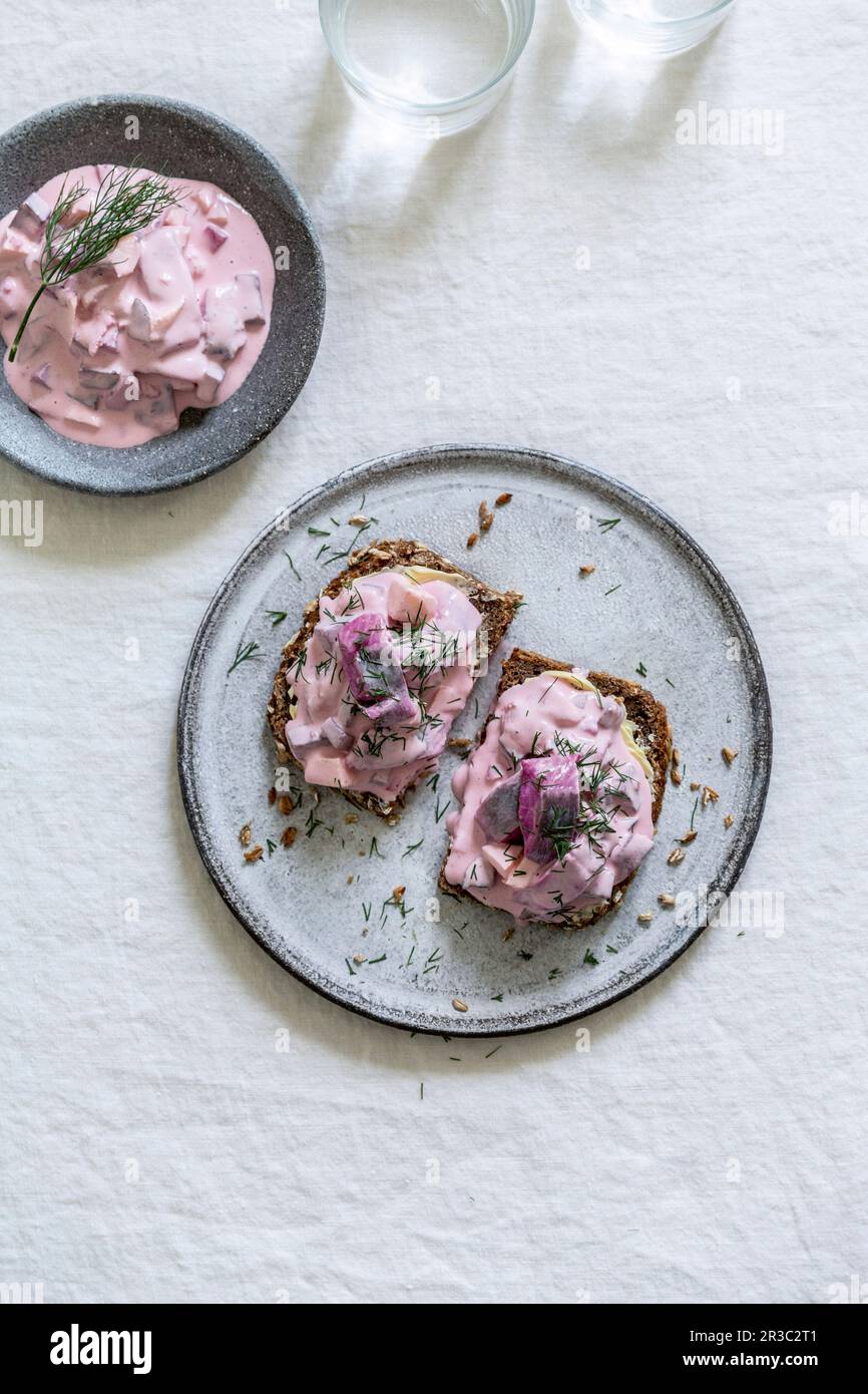 Herring salad on bread for a hangover breakfast Stock Photo - Alamy