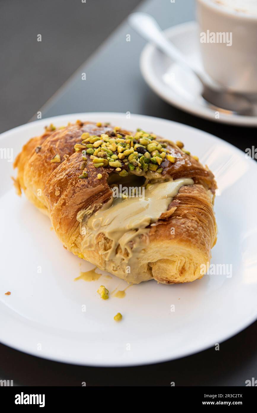 Sicilian pistachio cream filled cornetto Stock Photo - Alamy