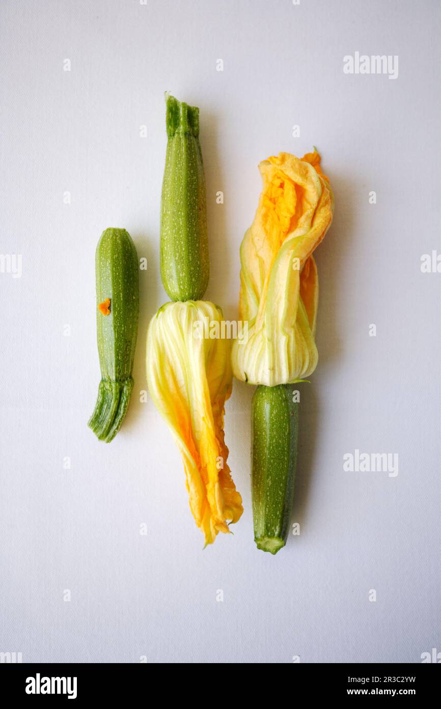 Mini zucchini with squash blossoms Stock Photo - Alamy