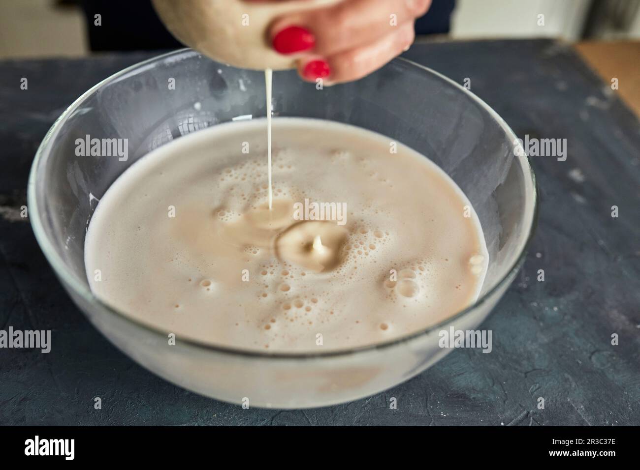Straining the mixed almonds through gauze. Making almond milk Stock ...