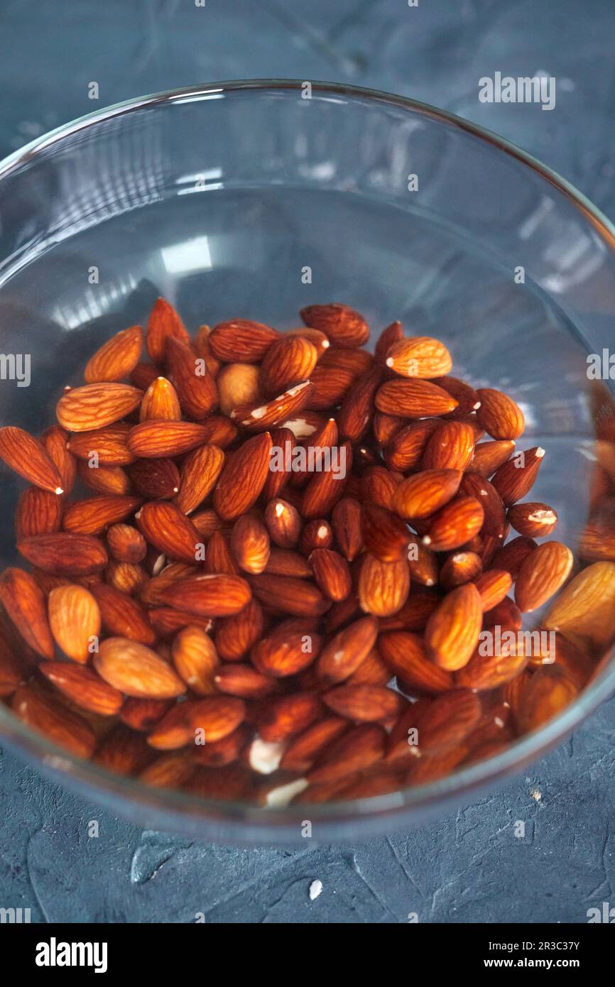 Almonds soaked in water Stock Photo - Alamy