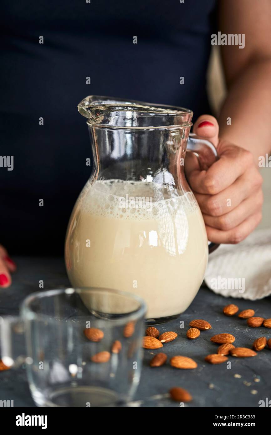 Pouring homemade almond milk into a jug Stock Photo - Alamy