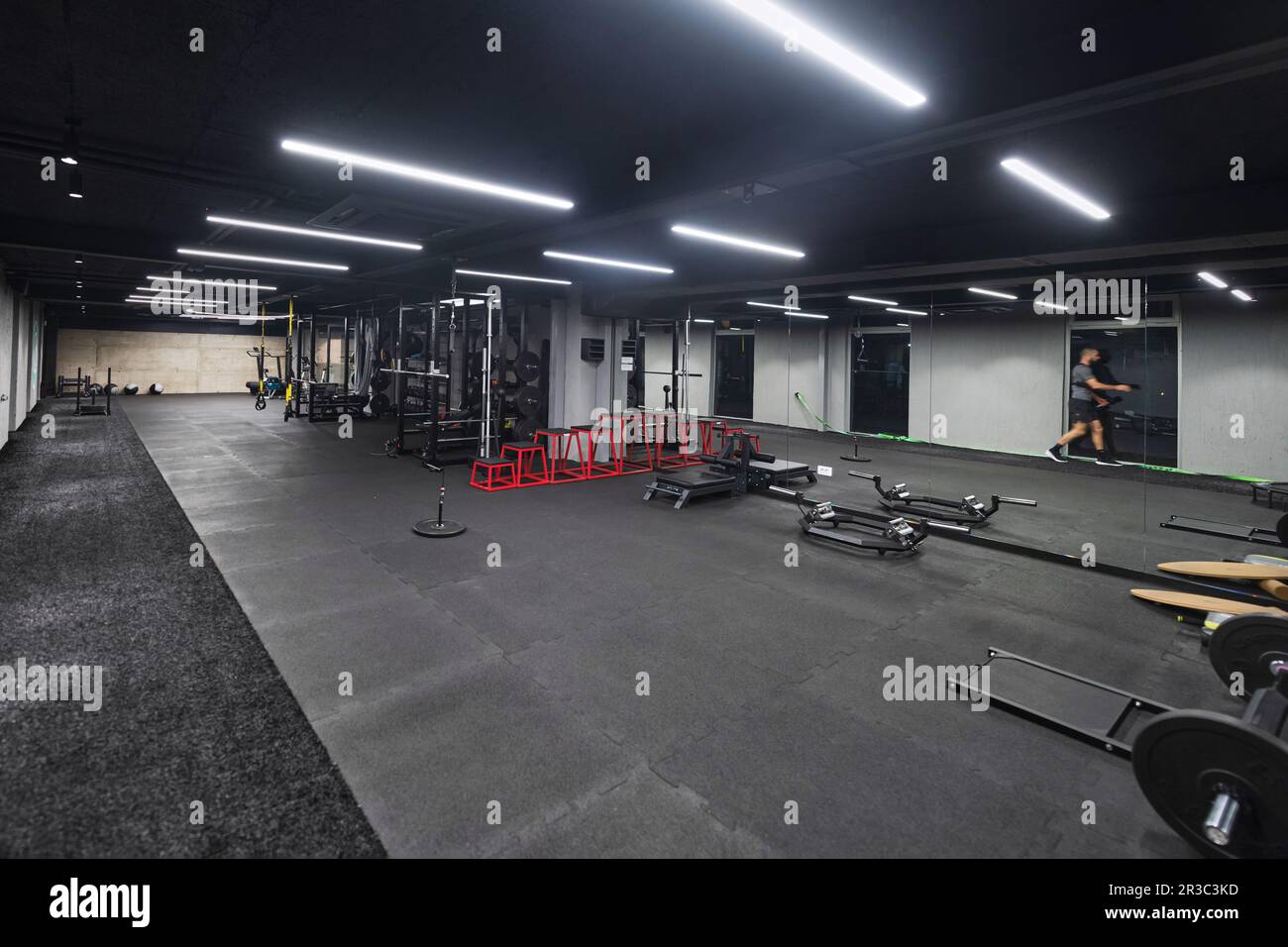 An empty modern gymnasium with a variety of equipment, offering a ...