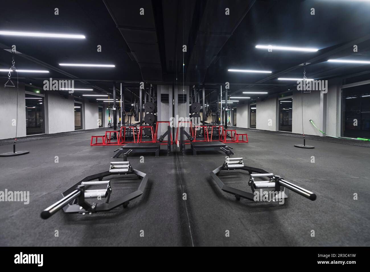 An empty modern gymnasium with a variety of equipment, offering a ...