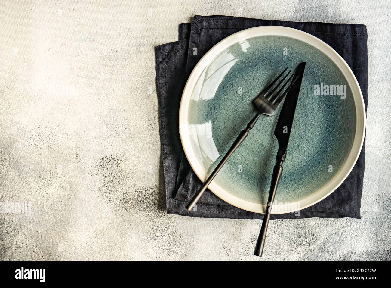 Simple place setting with ceramic plate Stock Photo - Alamy