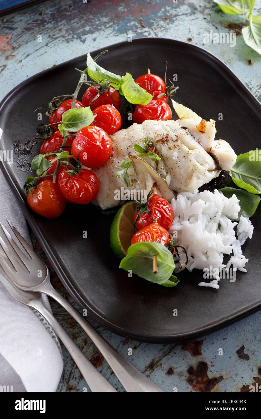 Rolled cod fillet with cherry tomatoes Stock Photo - Alamy
