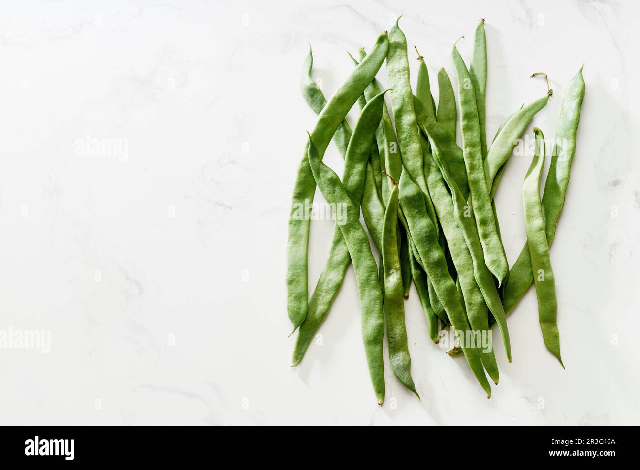 Romano flat green beans on white marble table top view Stock Photo - Alamy