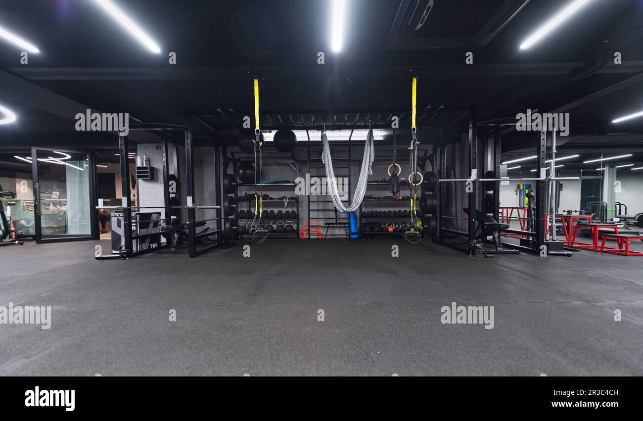 An empty modern gymnasium with a variety of equipment, offering a ...