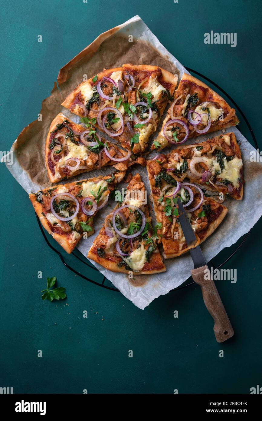 Vegan pizza with soy crumbles, onions and rocket, topped with a vegan ...