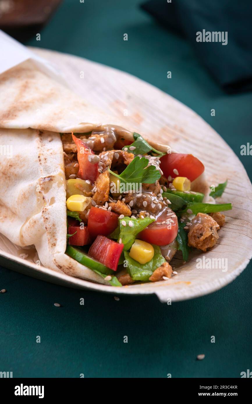 Arabic pita bread with a vegan patty, vegetables and tahini Stock Photo ...