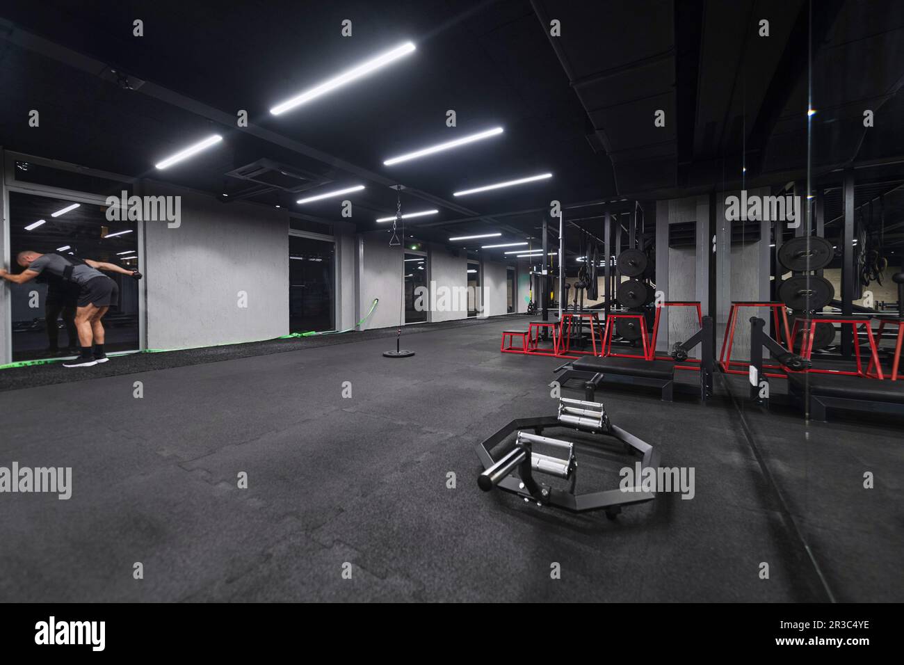 An empty modern gymnasium with a variety of equipment, offering a ...