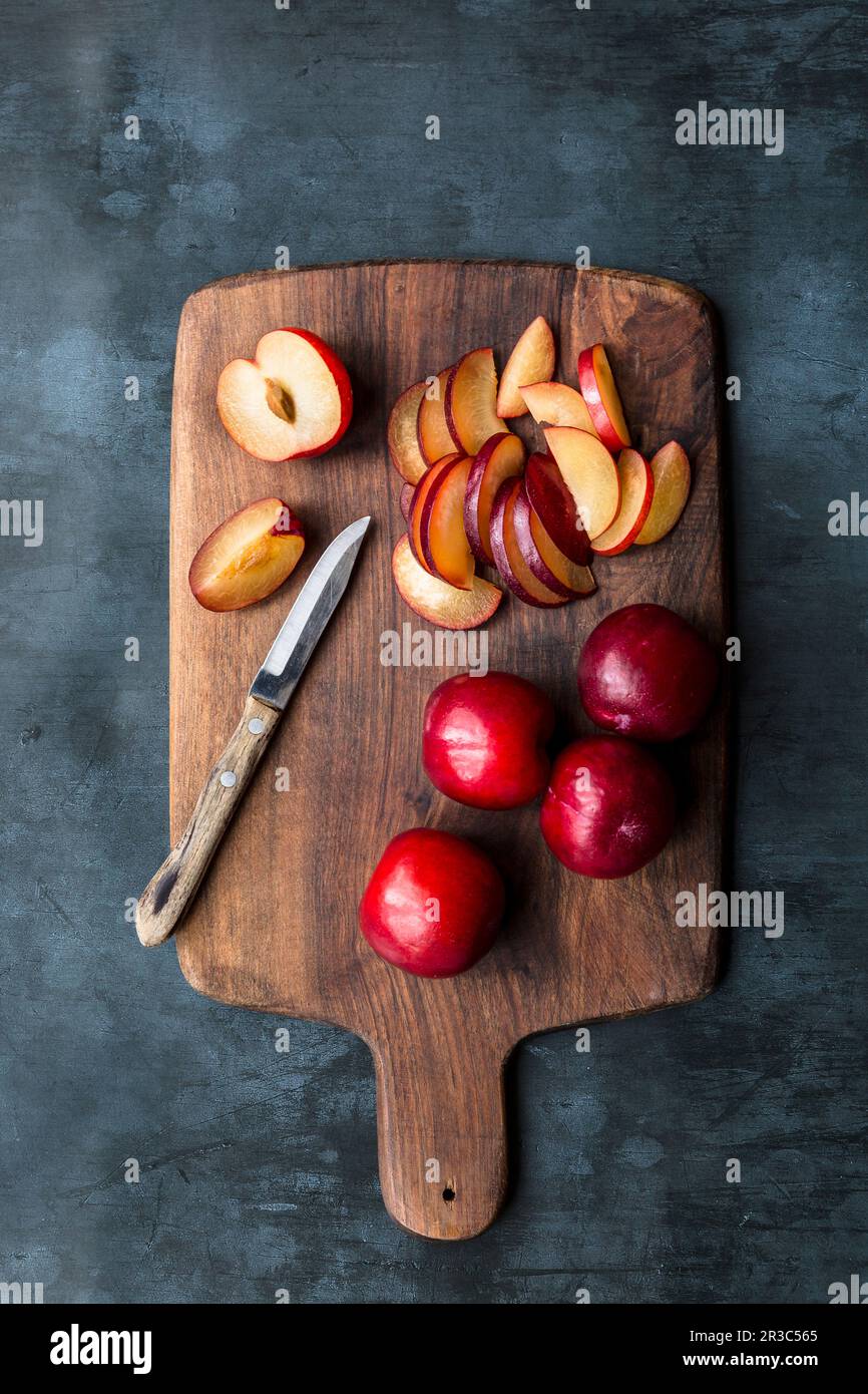 Plums, some sliced Stock Photo - Alamy