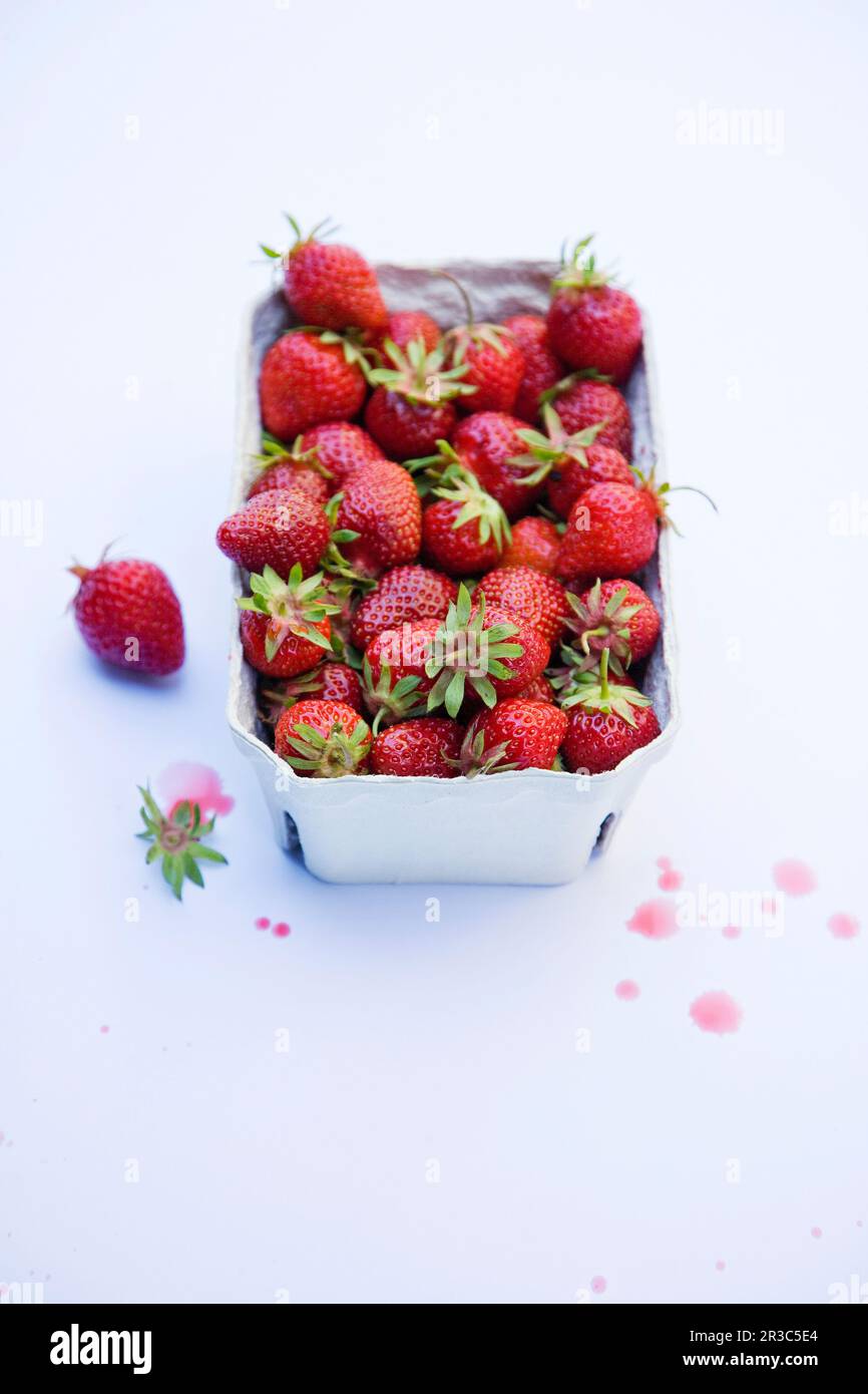 Fresh strawberries in a paper punnet Stock Photo - Alamy