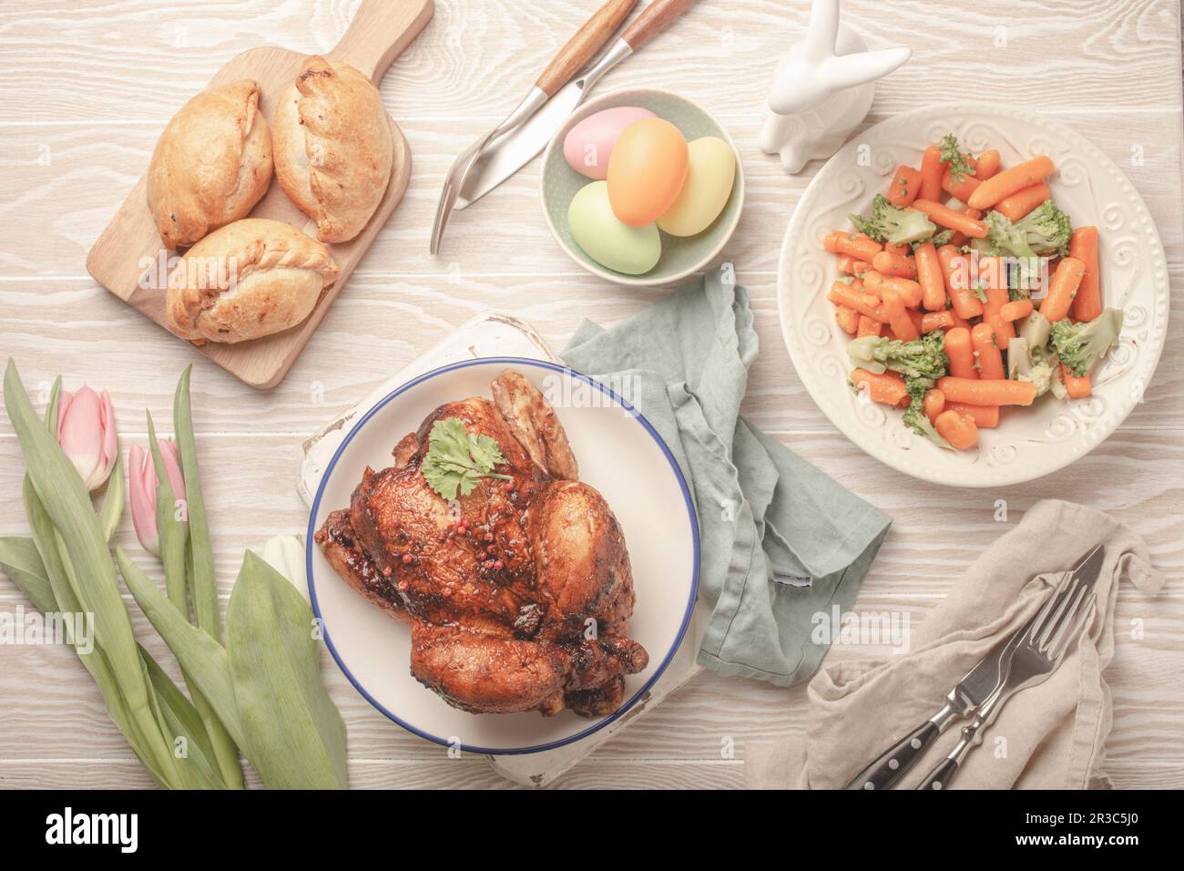 Easter food on white rustic table - pastel colored eggs, roasted ...