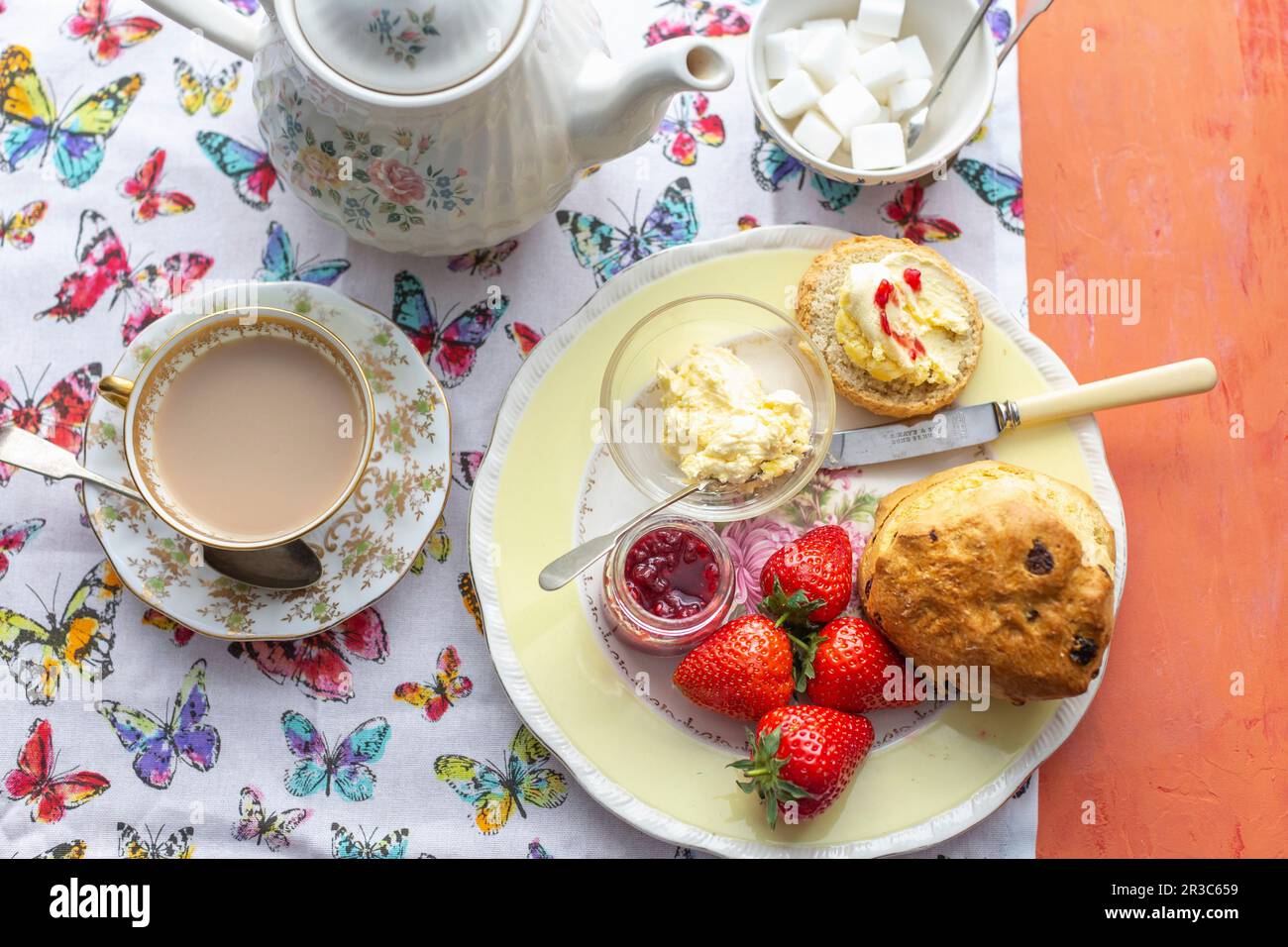Afternoon tea with scones, clotted cream, strawberries, jam and tea ...