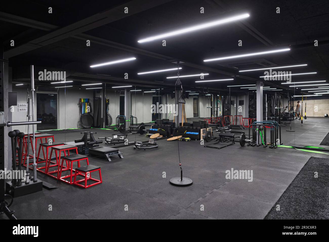 An empty modern gymnasium with a variety of equipment, offering a ...