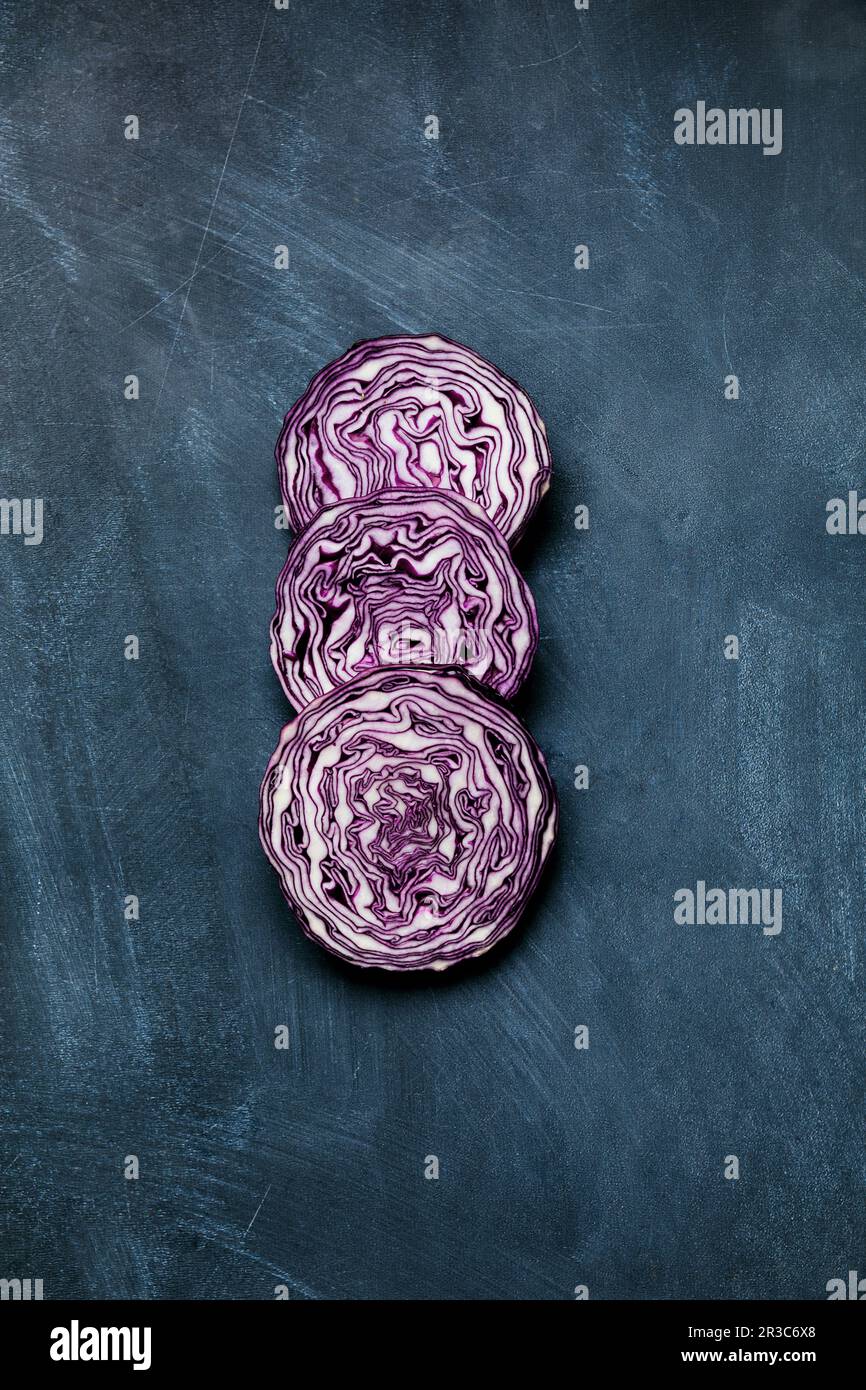 Red cabbage slices on a dark background Stock Photo - Alamy