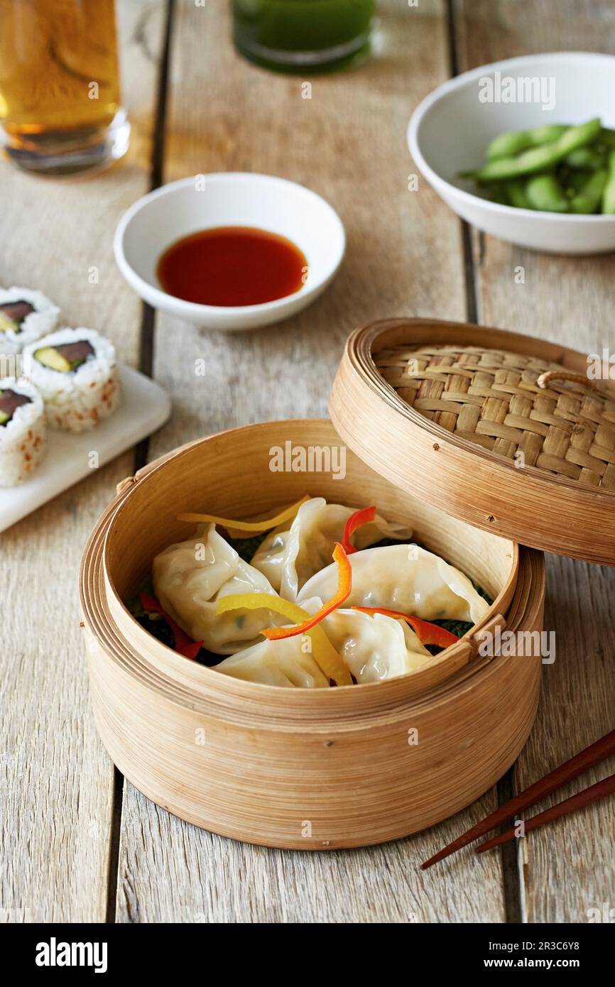 Gyoza and fresh peppers with sushi and edamame Stock Photo - Alamy