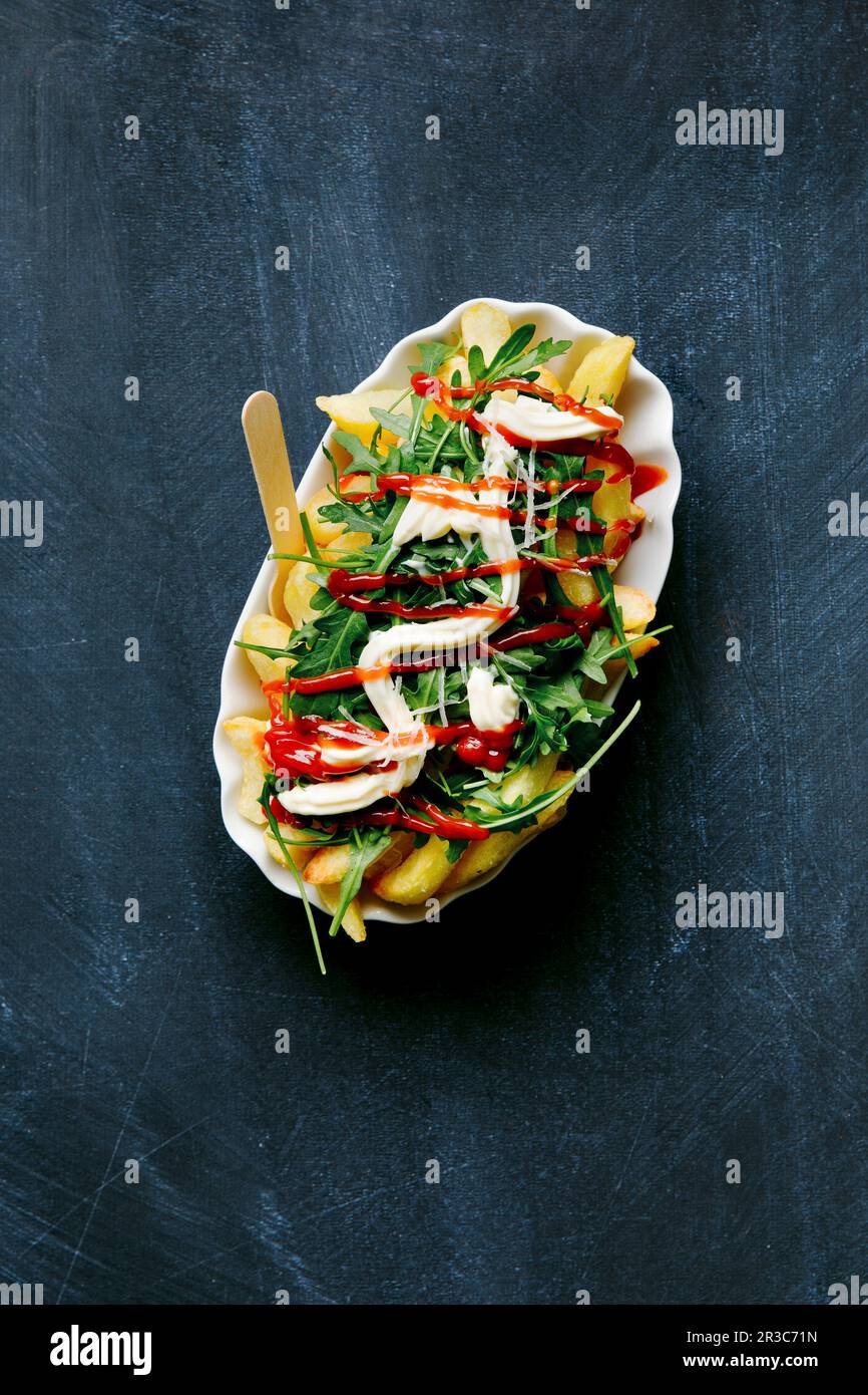 French fries with rocket, ketchup and vegan mayonnaise Stock Photo - Alamy