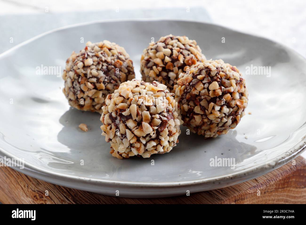 Healthy date and chocolate pralines coated in peanuts Stock Photo - Alamy