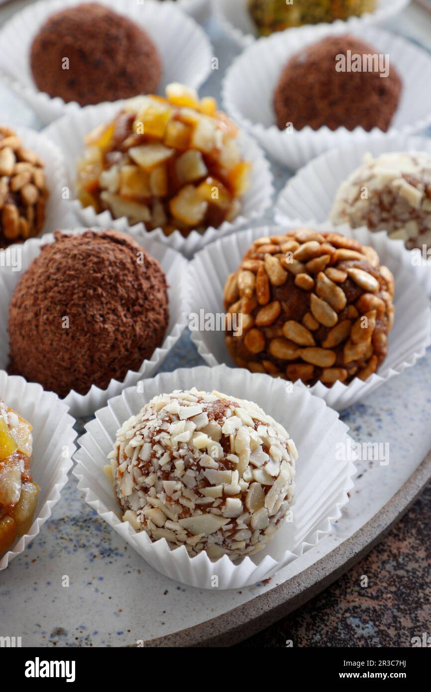 Healthy date and chocolate pralines coated in peanuts, roasted ...